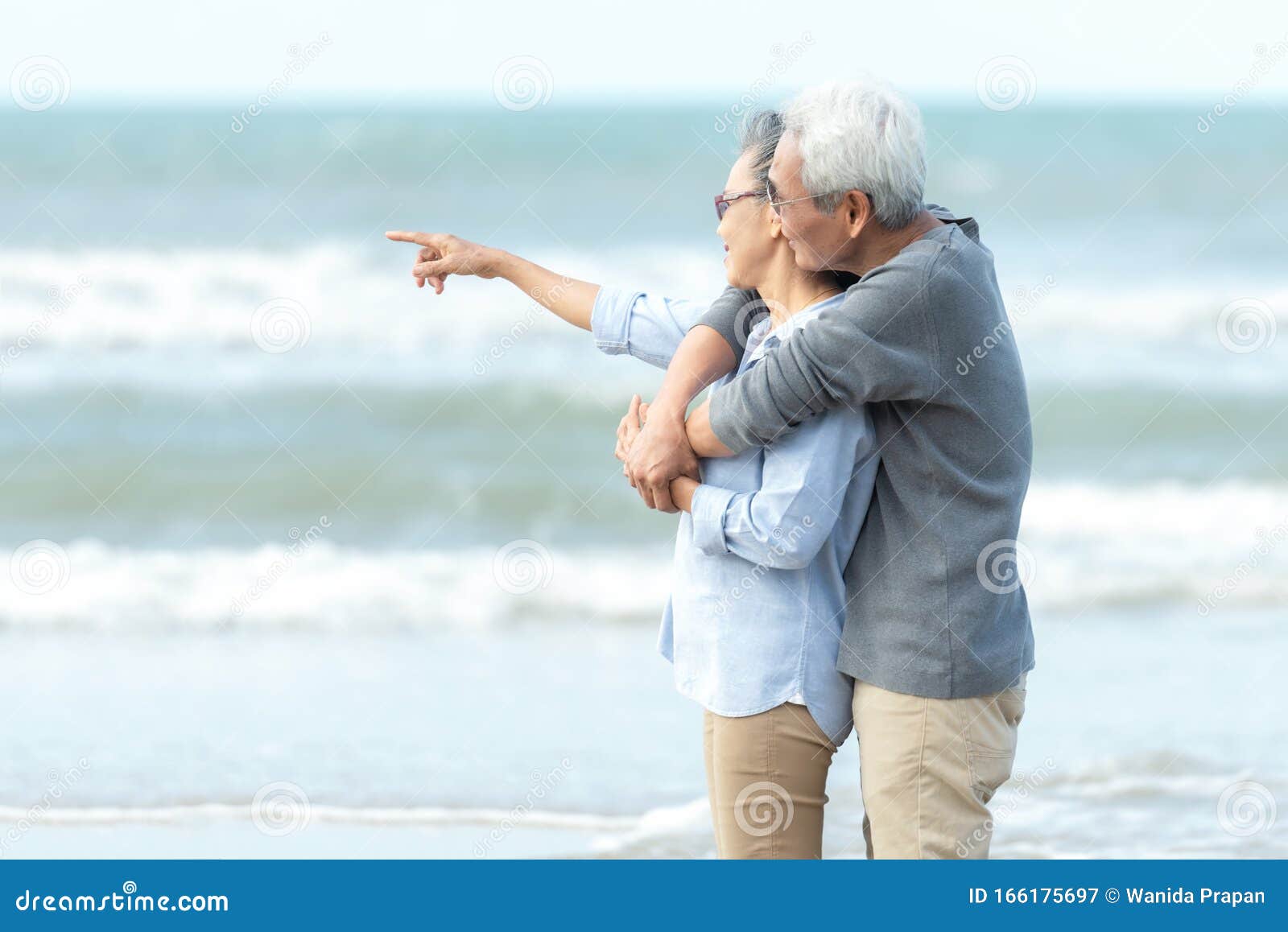 Asian Lifestyle Senior Couple Hug And Pointing The Landing Planes Or